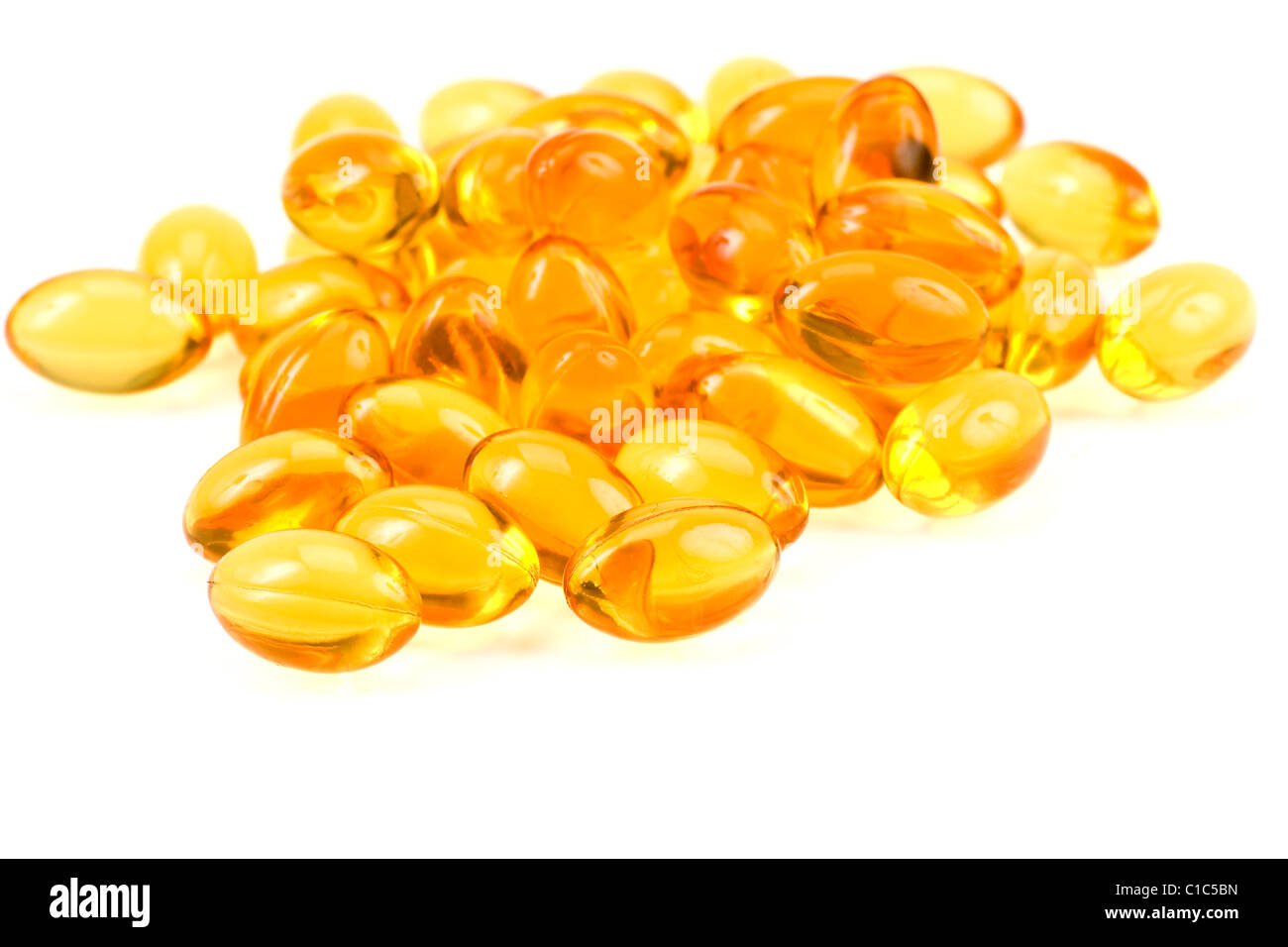 Transparent gold fish oil pills close-up Stock Photo - Alamy