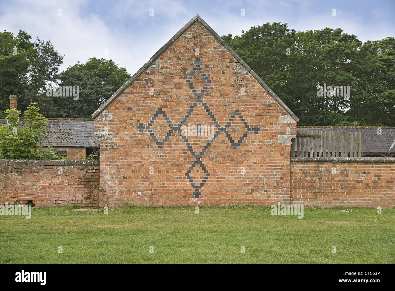 Decorative brickwork on the gable end of old farm buildings at Hardwick ...