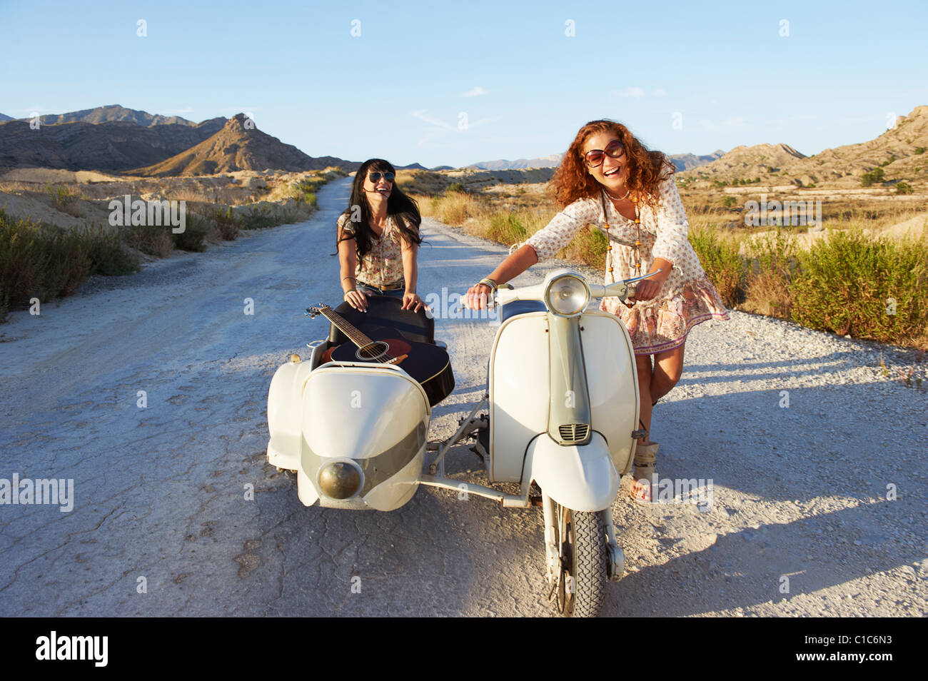 Women pushing motorbike and sidecar Stock Photo - Alamy