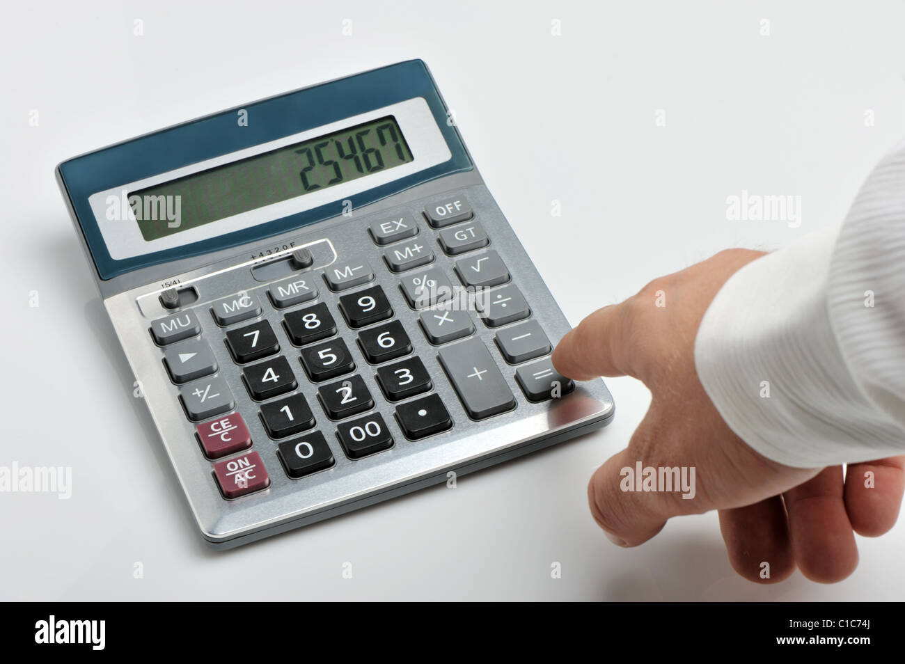 The calculator and a hand of the man. Pressing of a key of the ...