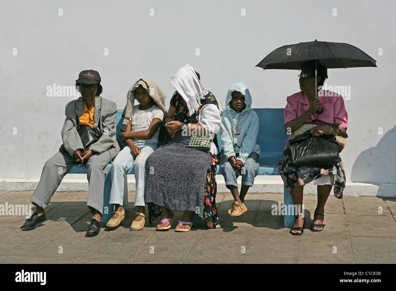 Family of five sitting on a bench in Antananarivo, capital of ...