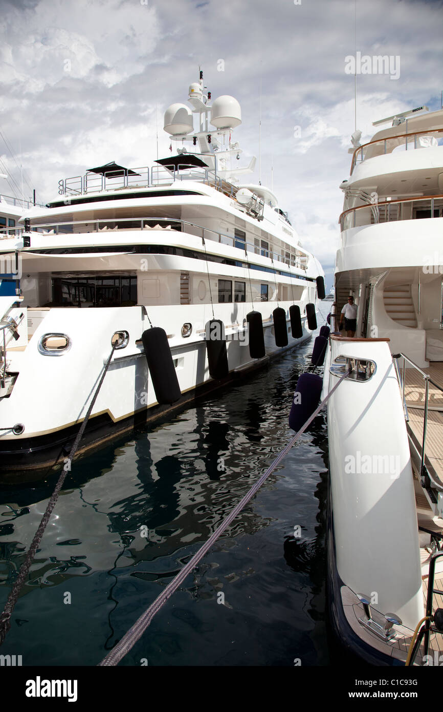Two large boats berthed alongside each other in Port Hercules, Monaco ...