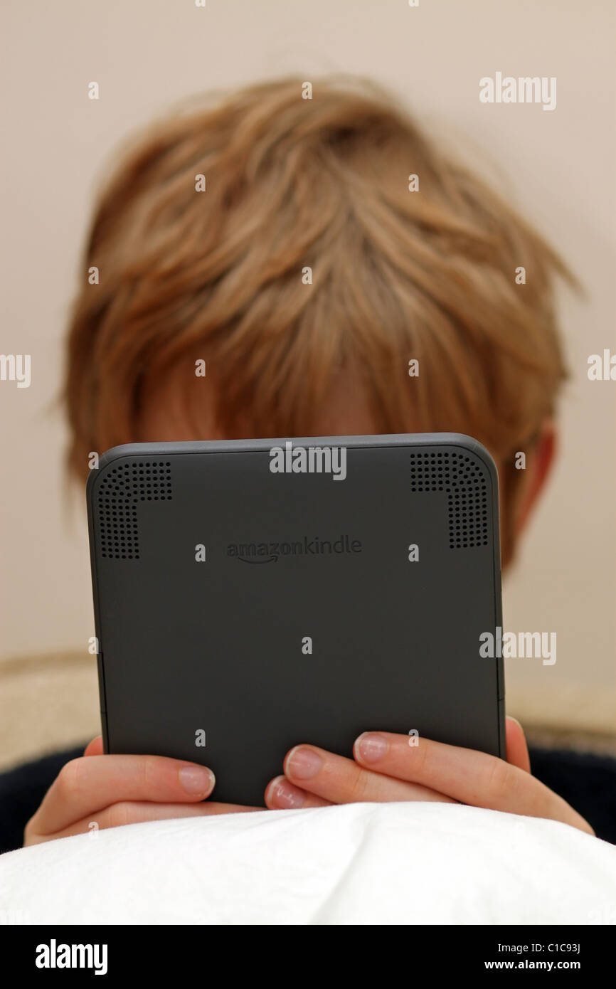 Boy reading Kindle Stock Photo - Alamy