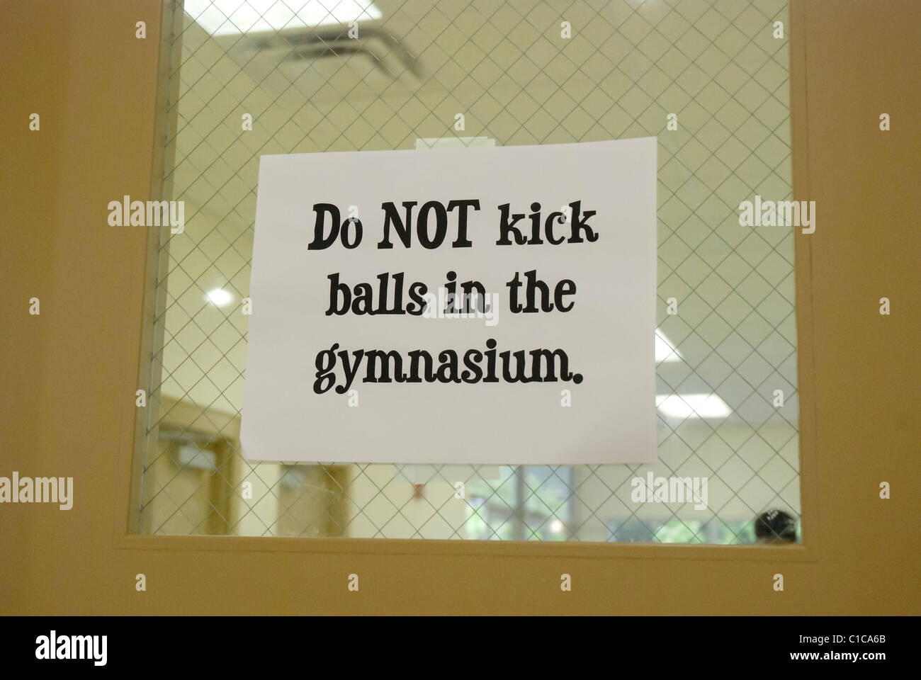 sign posted on gym door prohibiting kicking of balls inside facility ...