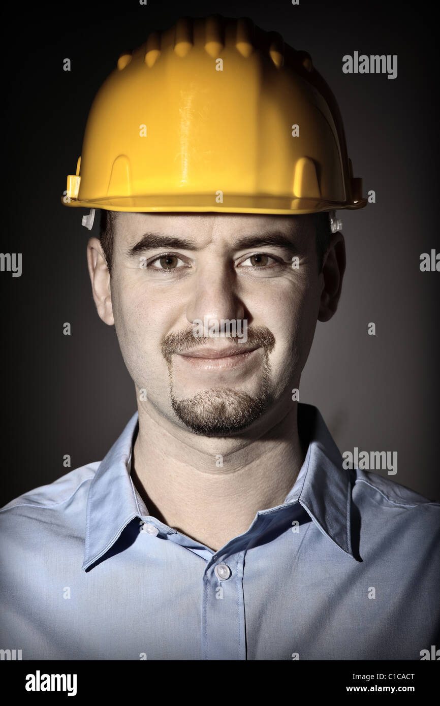 fine closeup portrait of young engineer with helmet Stock Photo - Alamy