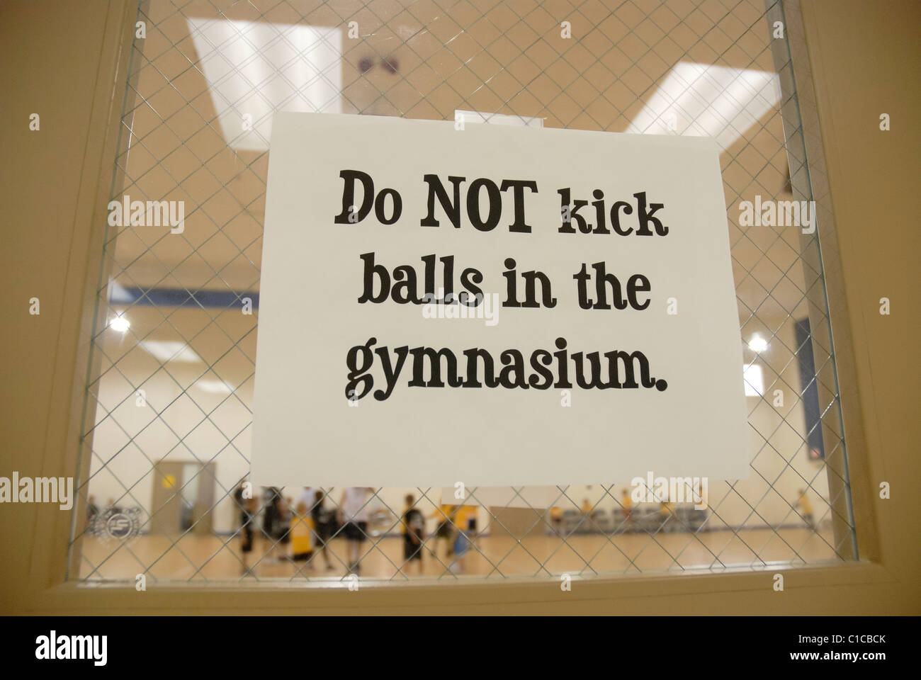 sign posted on gym door prohibiting kicking of balls inside facility ...