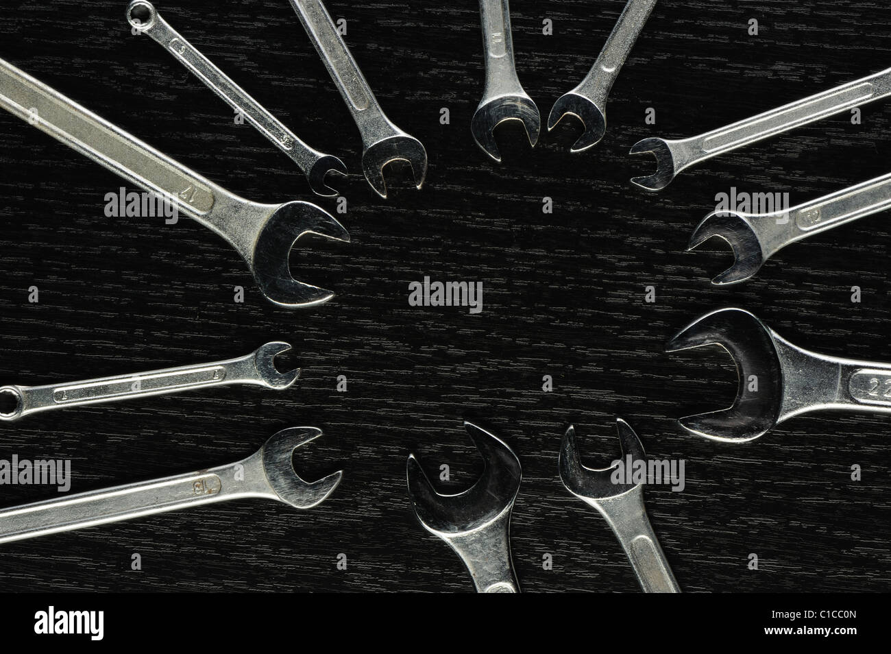 Wrenches. Wrenches on a black wooden surface Stock Photo - Alamy