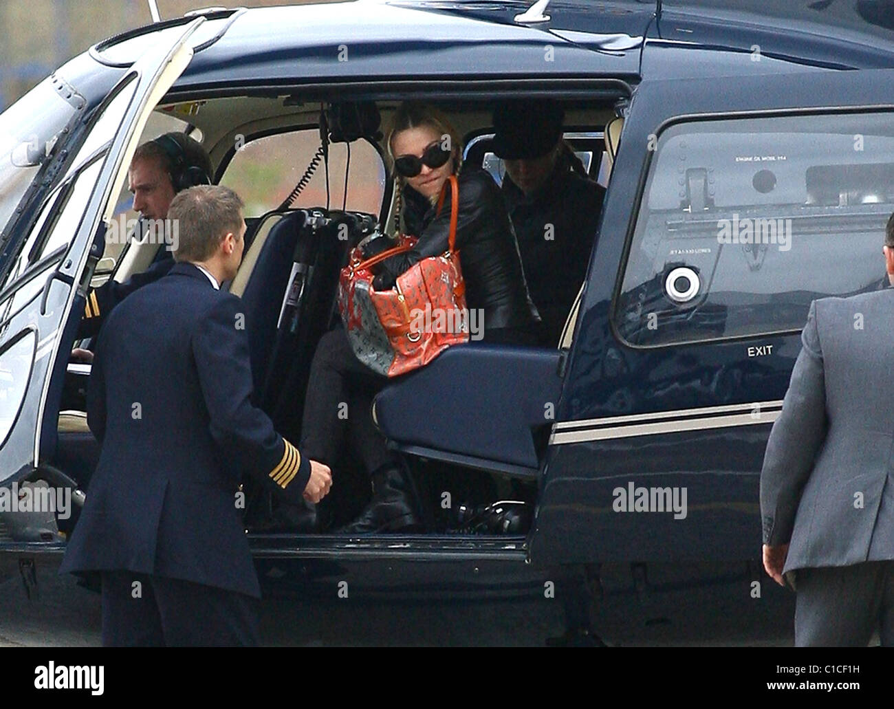 Madonna takes a helicopter ride from Battersea, carrying a large Louis ...