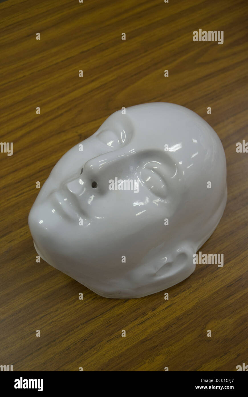 white plastic mask lying on table Stock Photo - Alamy