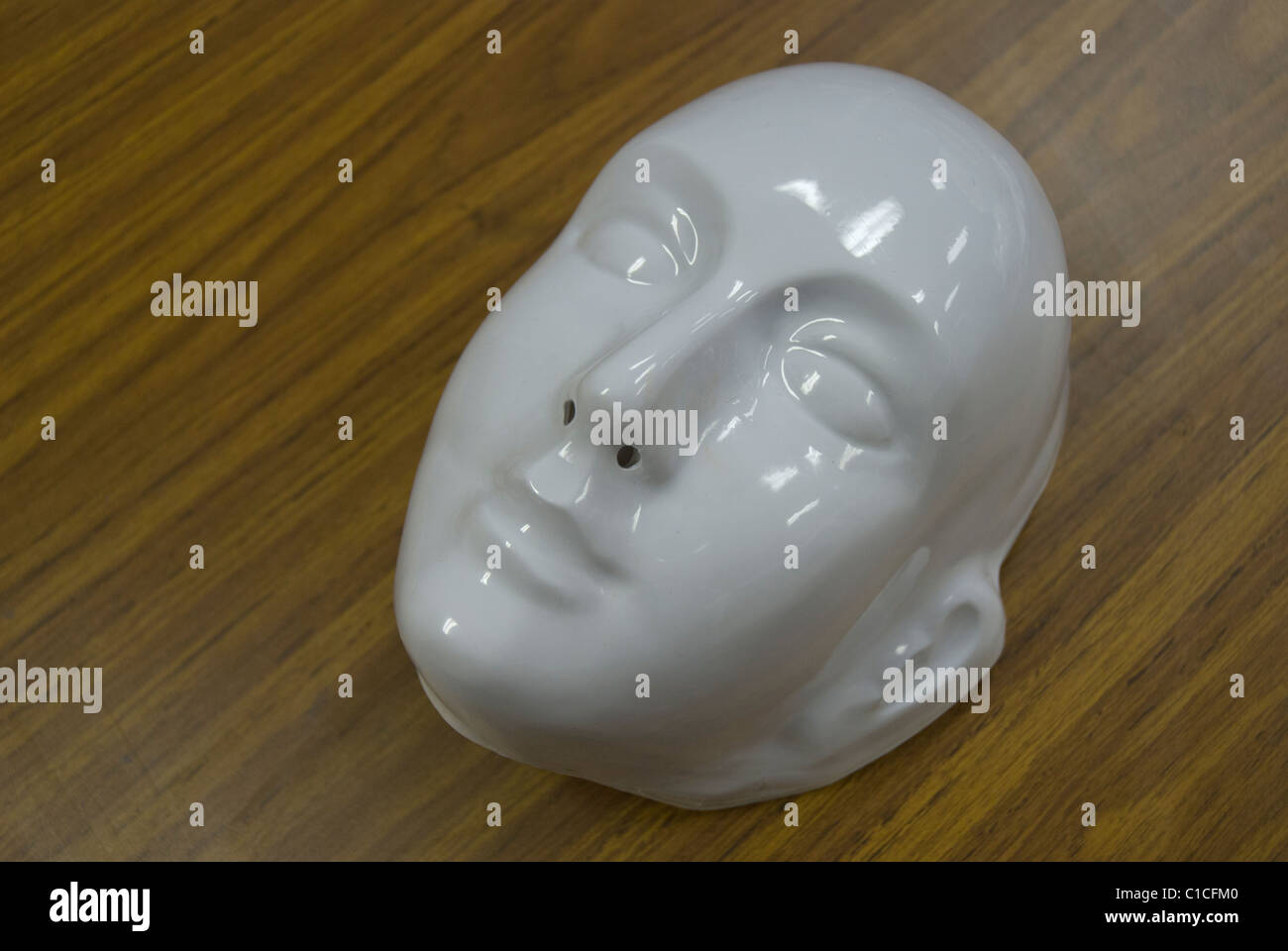 white plastic mask lying on table Stock Photo - Alamy