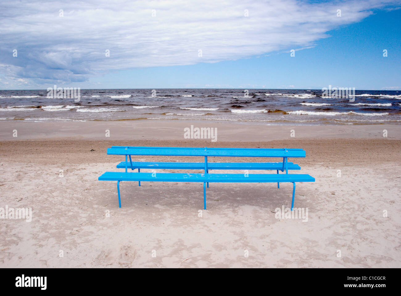 Blue bench on the beach sand near the sea Stock Photo - Alamy