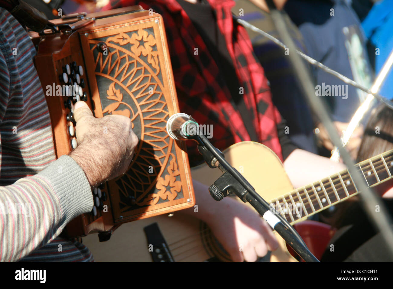 detail of person with musical instrument outdoors in sun Stock Photo ...