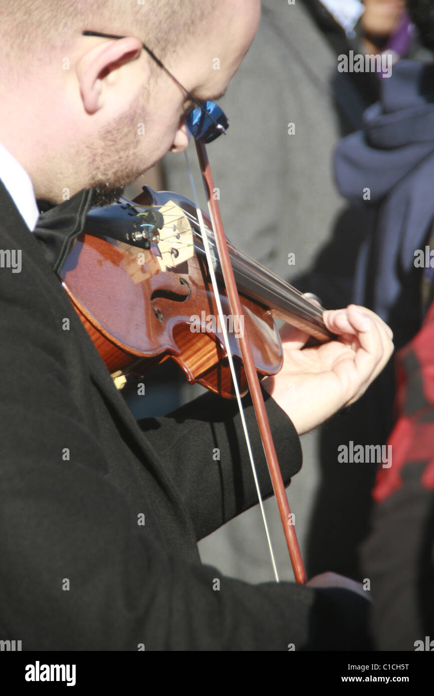 detail of person with musical instrument outdoors in sun Stock Photo ...