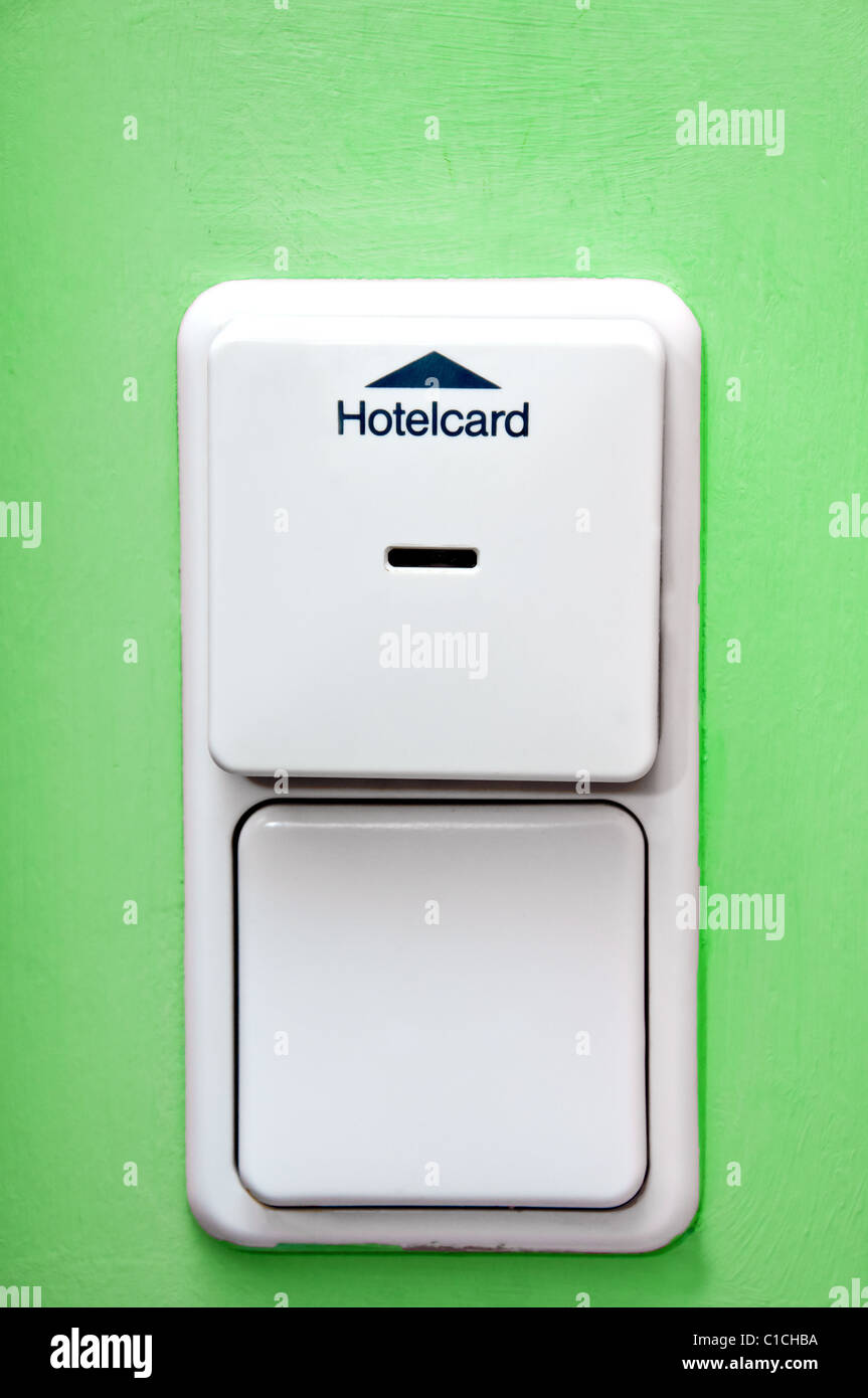 hotel card holder on green wall and light switch Stock Photo - Alamy