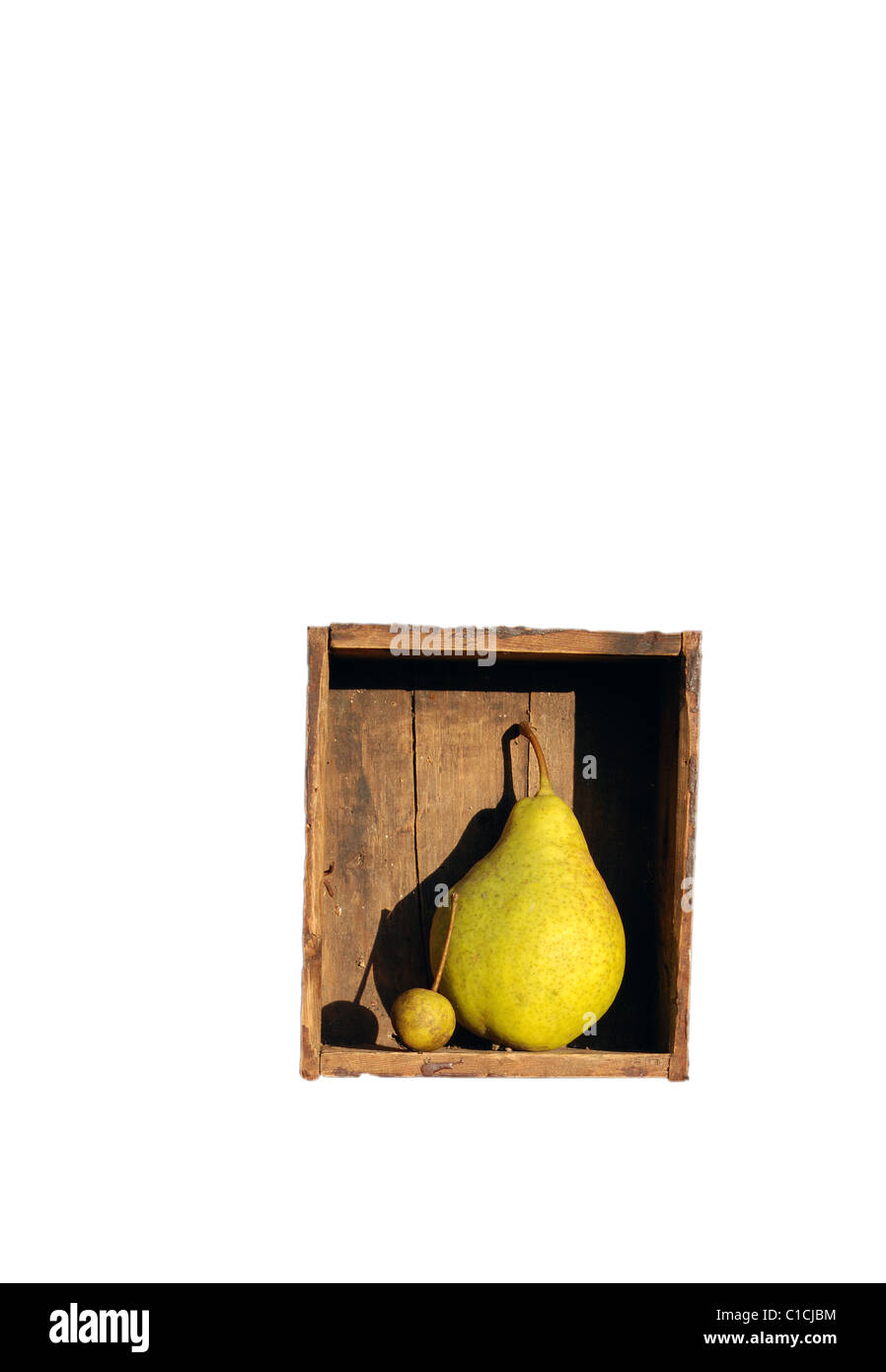 Big and small pears in old box in white background Stock Photo - Alamy