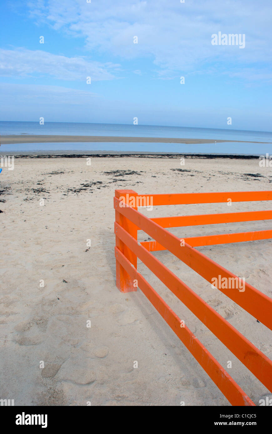Orange decorative fence on the beach sand Stock Photo - Alamy