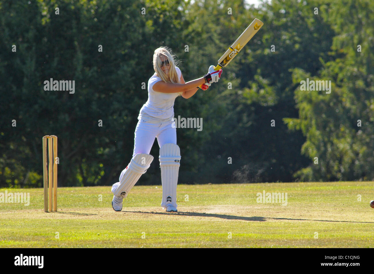 Woman hitting cricket ball hi-res stock photography and images - Alamy