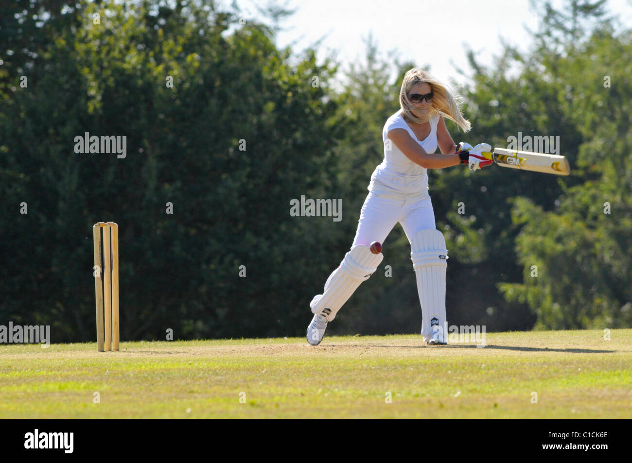 Woman hitting cricket ball hi-res stock photography and images - Alamy