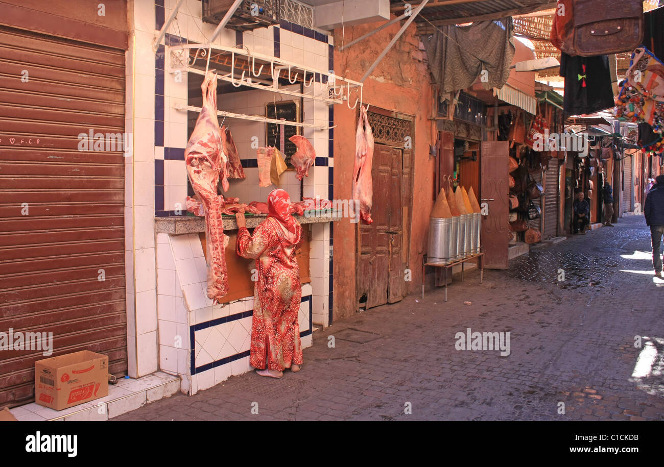 A local woman buys meat from a butcher in Marrakesh Stock Photo - Alamy