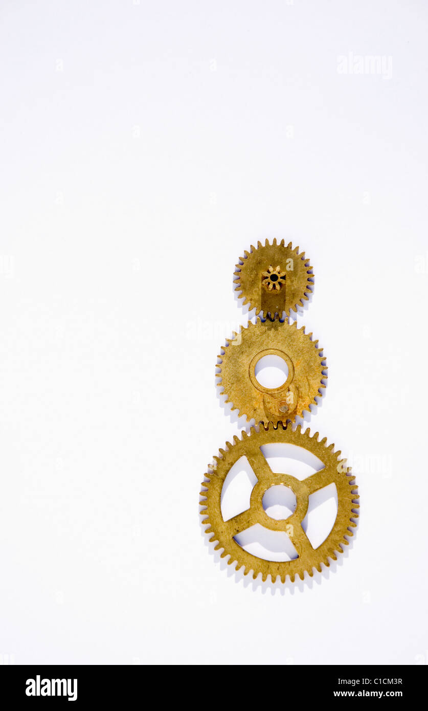 Three clock circles made of brass in a white background Stock Photo - Alamy