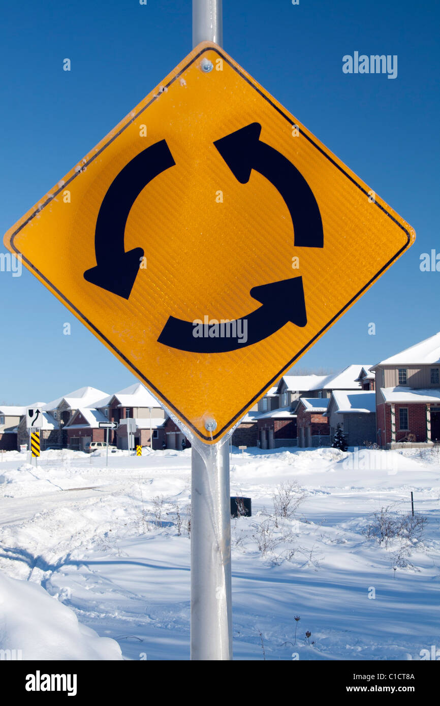 Roundabout reflective sign in Canadian suburb in winter Stock Photo - Alamy