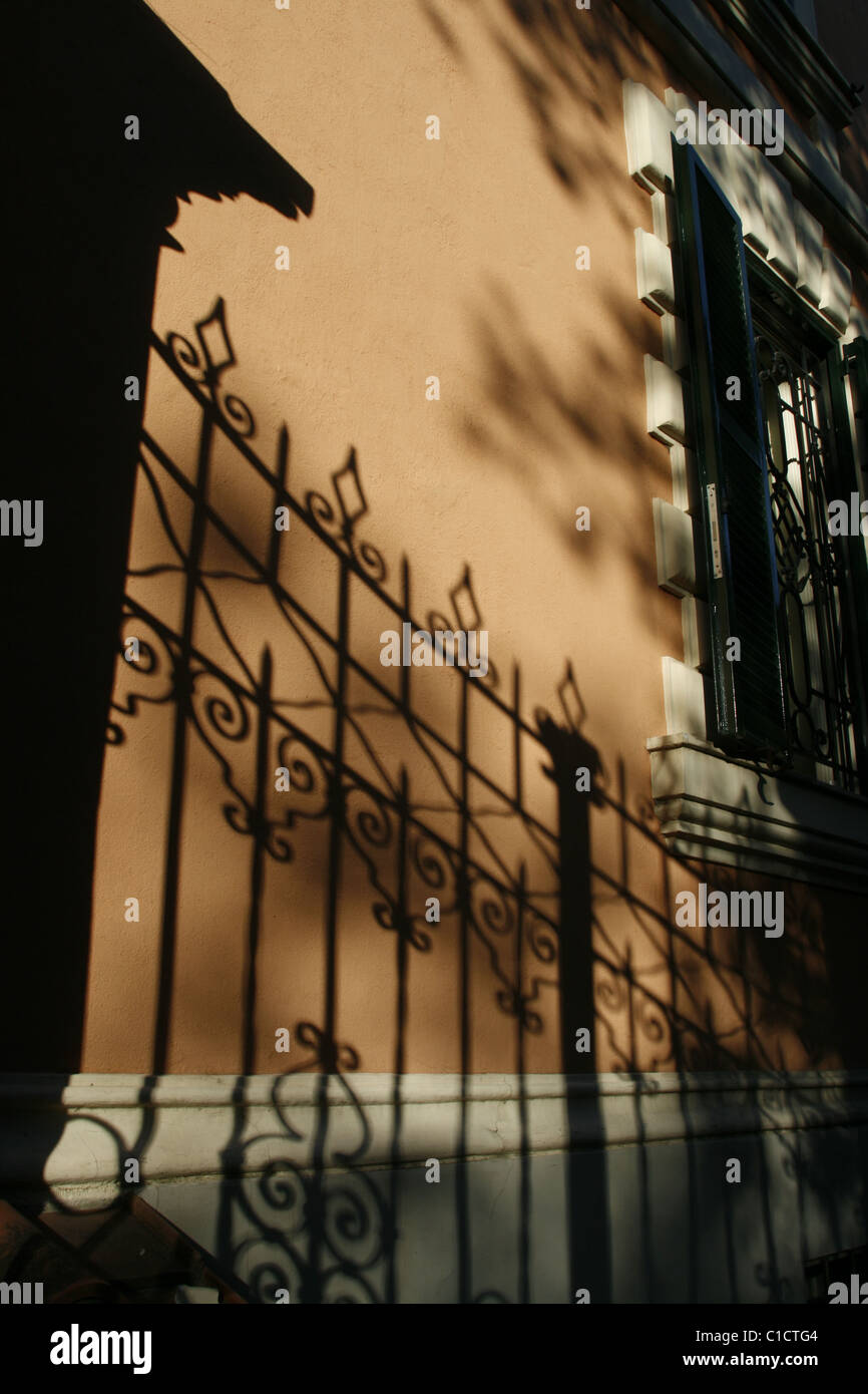 Shadow of iron gate on wall hi-res stock photography and images - Alamy