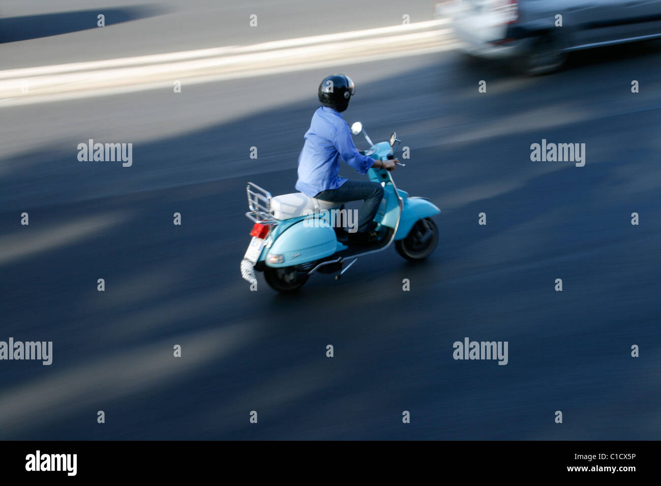 person riding fast vespa lambretta type scooter moped in rome italy ...