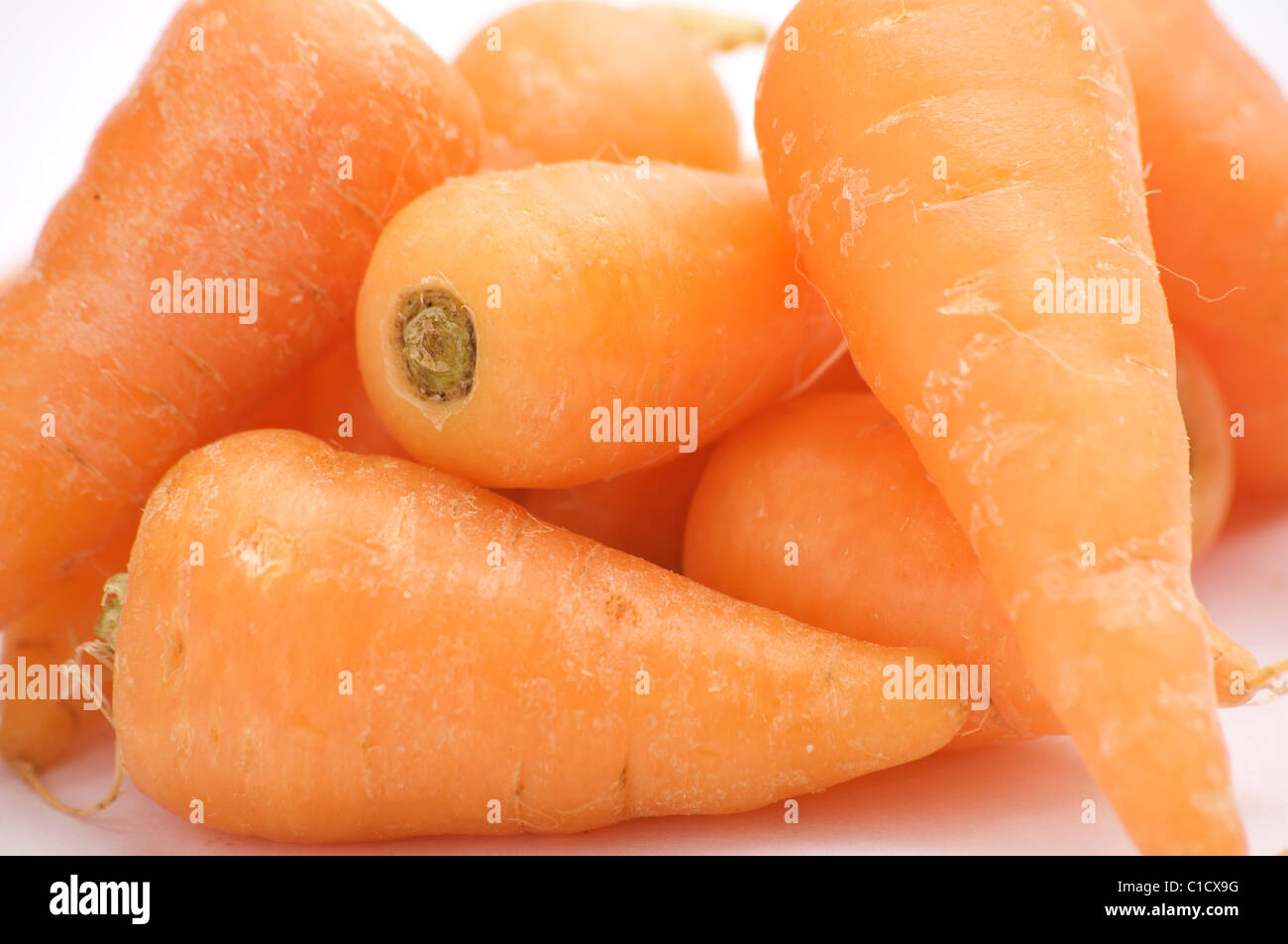 Fresh baby Carrots, isolated on a white background table, lit with a ...