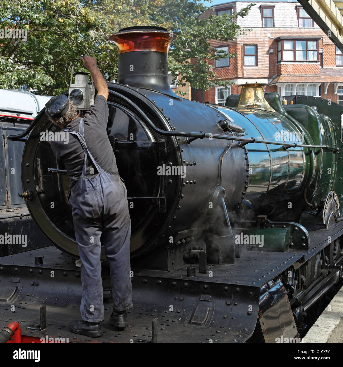 Engineer in Blue Overalls Placing Oil Headlight on Steam Locomotive ...