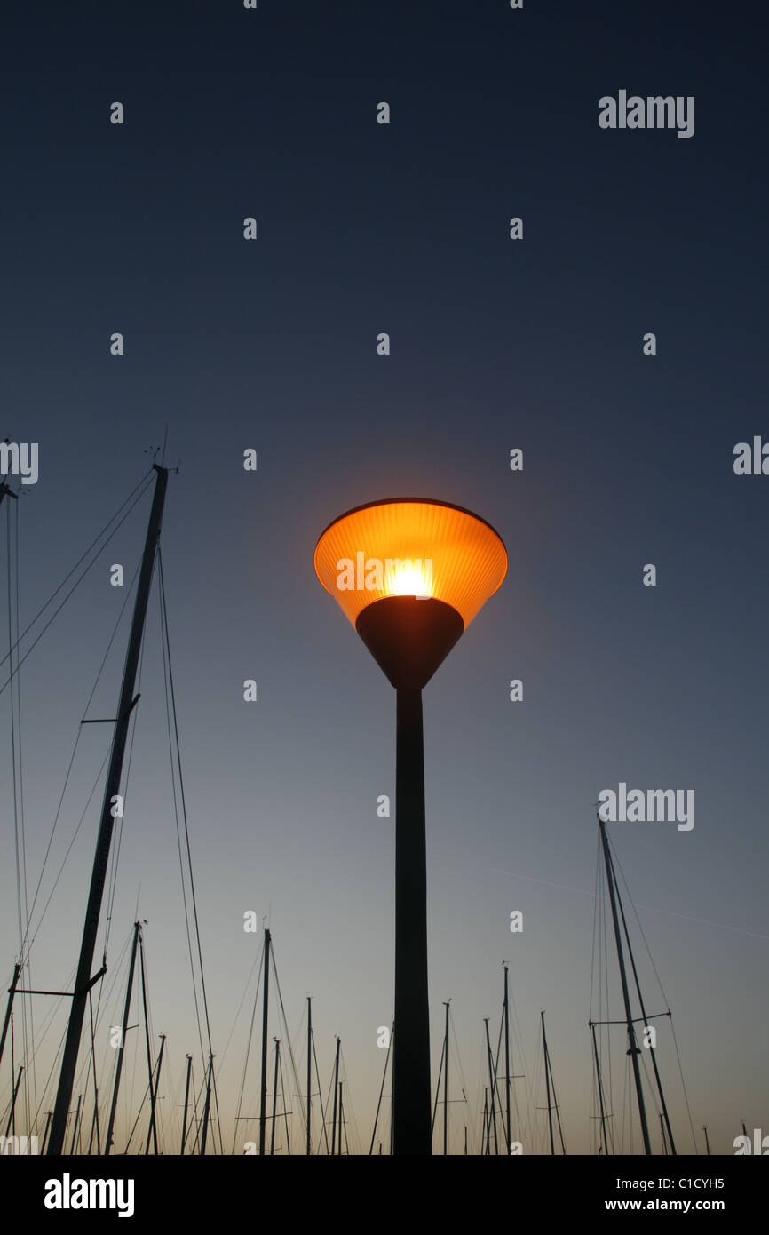 boats masts and street light in port dock at night Stock Photo - Alamy