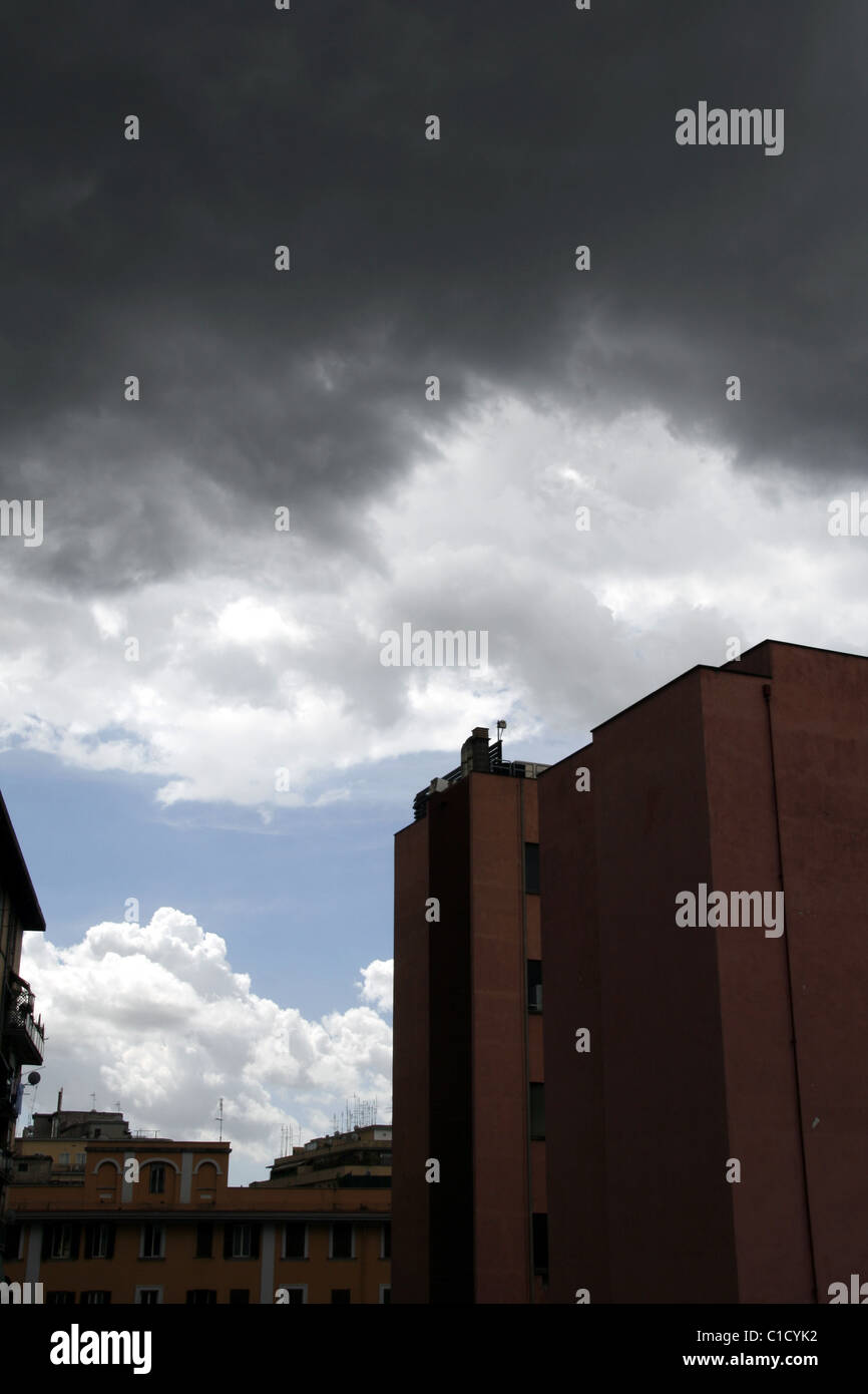 dark storm clouds over buildings in rome italy Stock Photo - Alamy