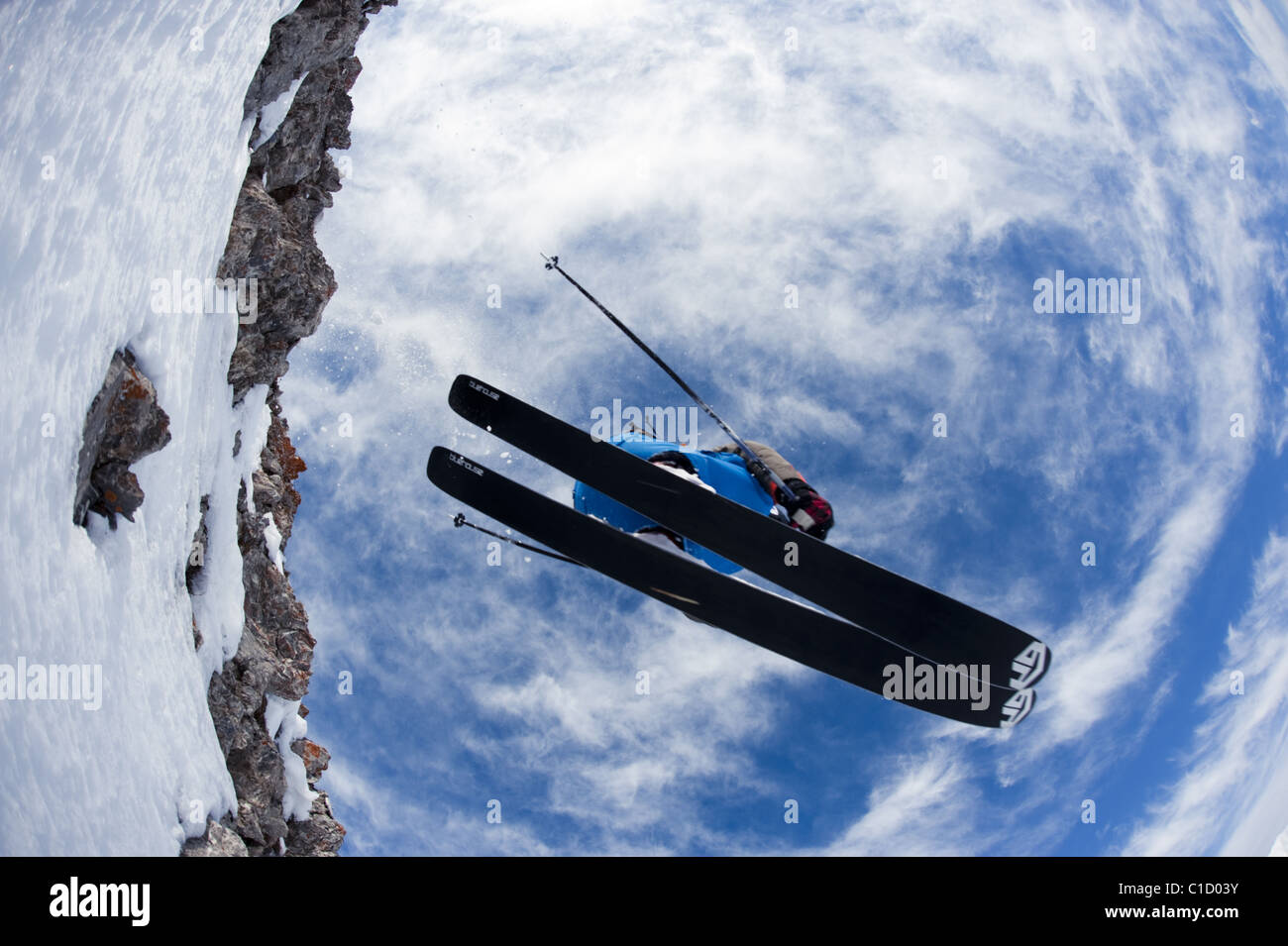 A free skier dropping down a cliff in Argentera, Italy. The skier is ...