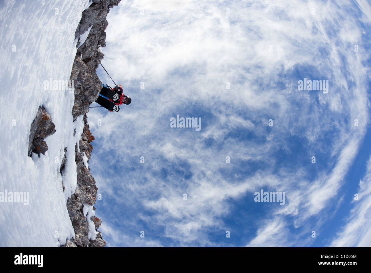 A free skier dropping down a cliff in Argentera, Italy. The skier is ...