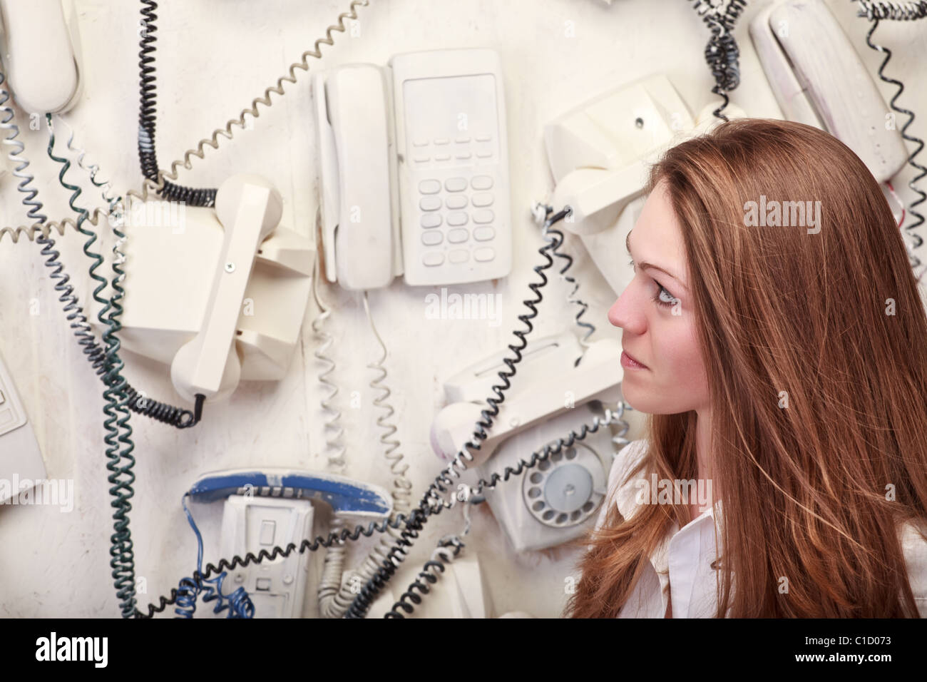 woman with vintage phones on wall Stock Photo - Alamy