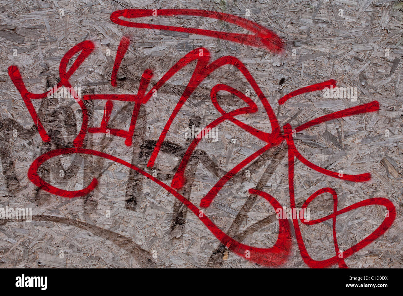 Bright red graffiti spray painted onto a chipboard surface Stock Photo ...