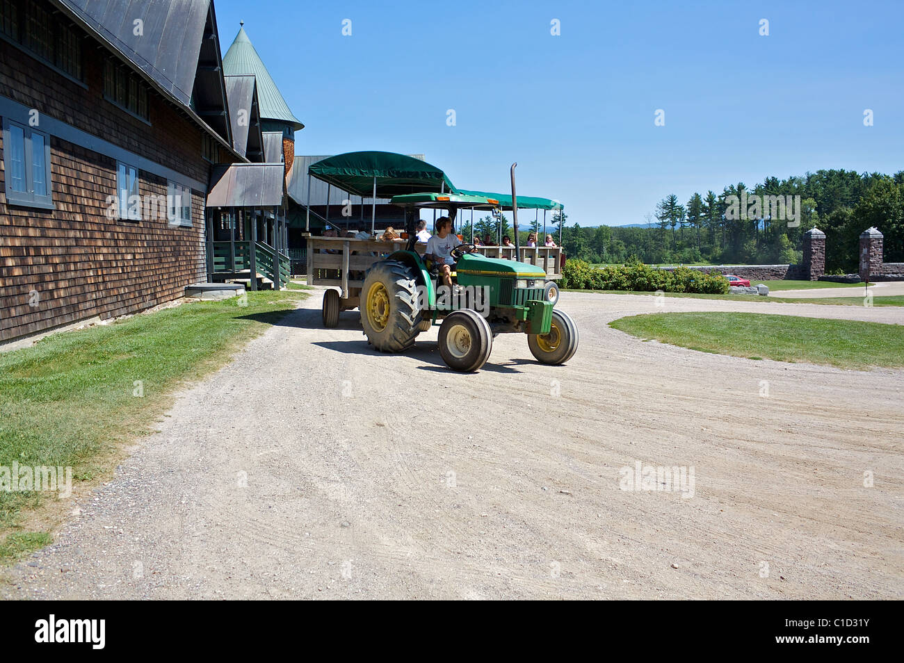A tractor drives visitors around Shelburne Farms, a working farm and ...