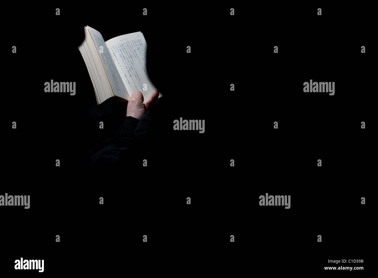 A Japanese man pictured reading a Japanese book on a flight to Japan ...
