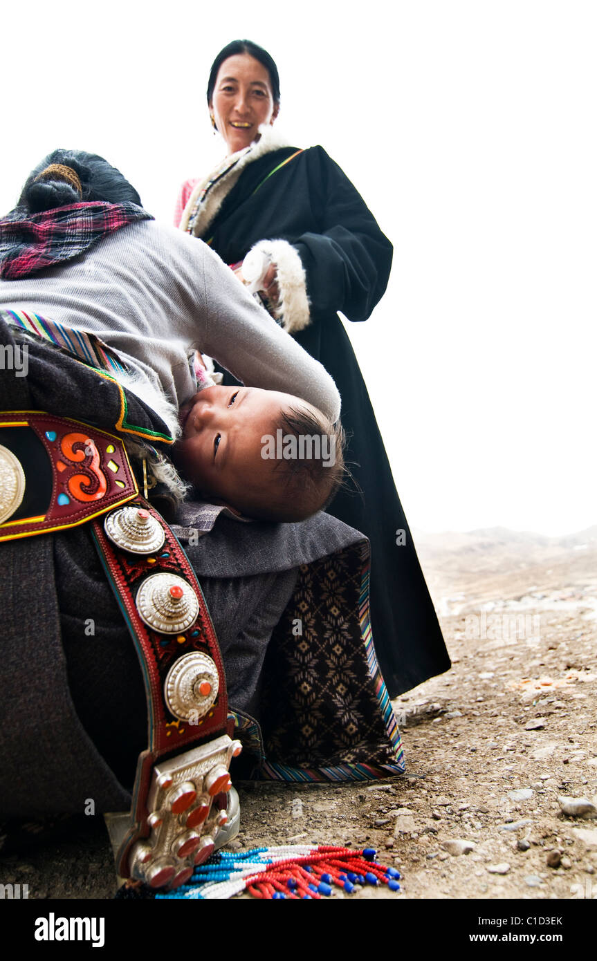 A cute Tibetan baby in his mother's hands Stock Photo - Alamy