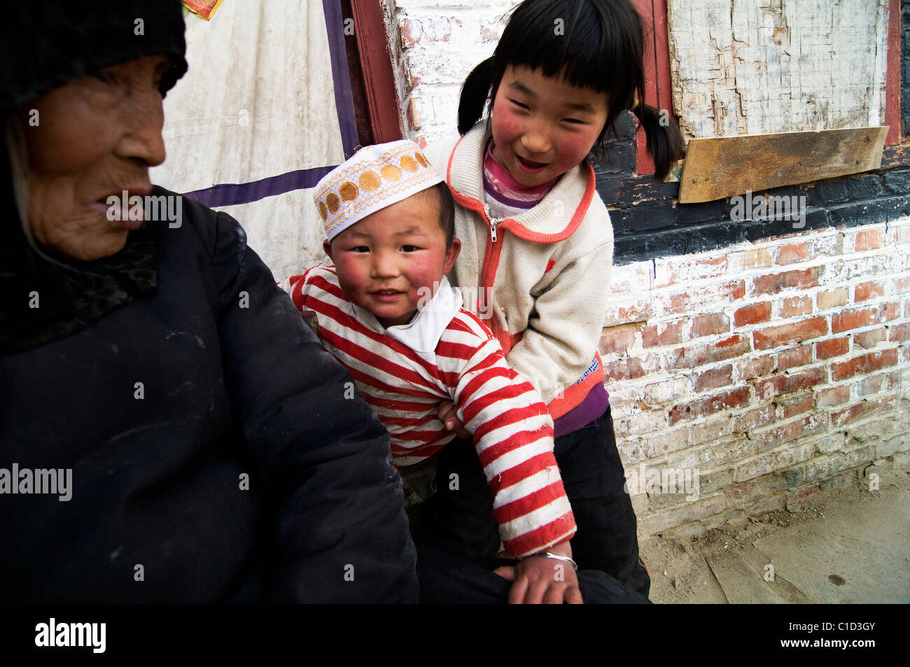 Hui Muslim children with their grandmother Stock Photo - Alamy