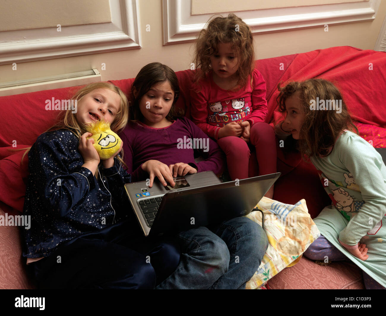 Girls Playing Computer Game On A Laptop In The Living Room Stock Photo ...