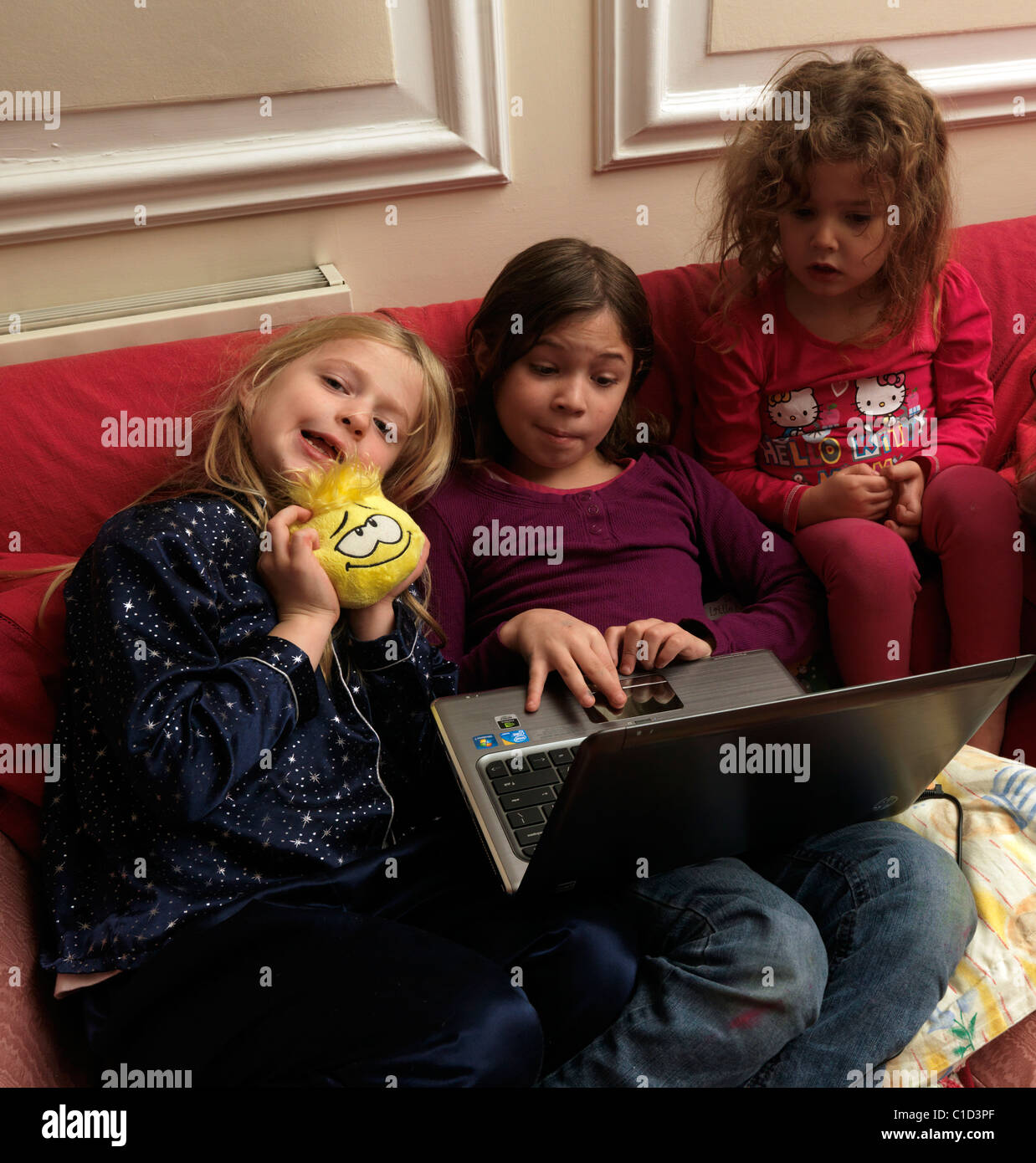 Girls Playing Computer Game On A Laptop In The Living Room Stock Photo ...