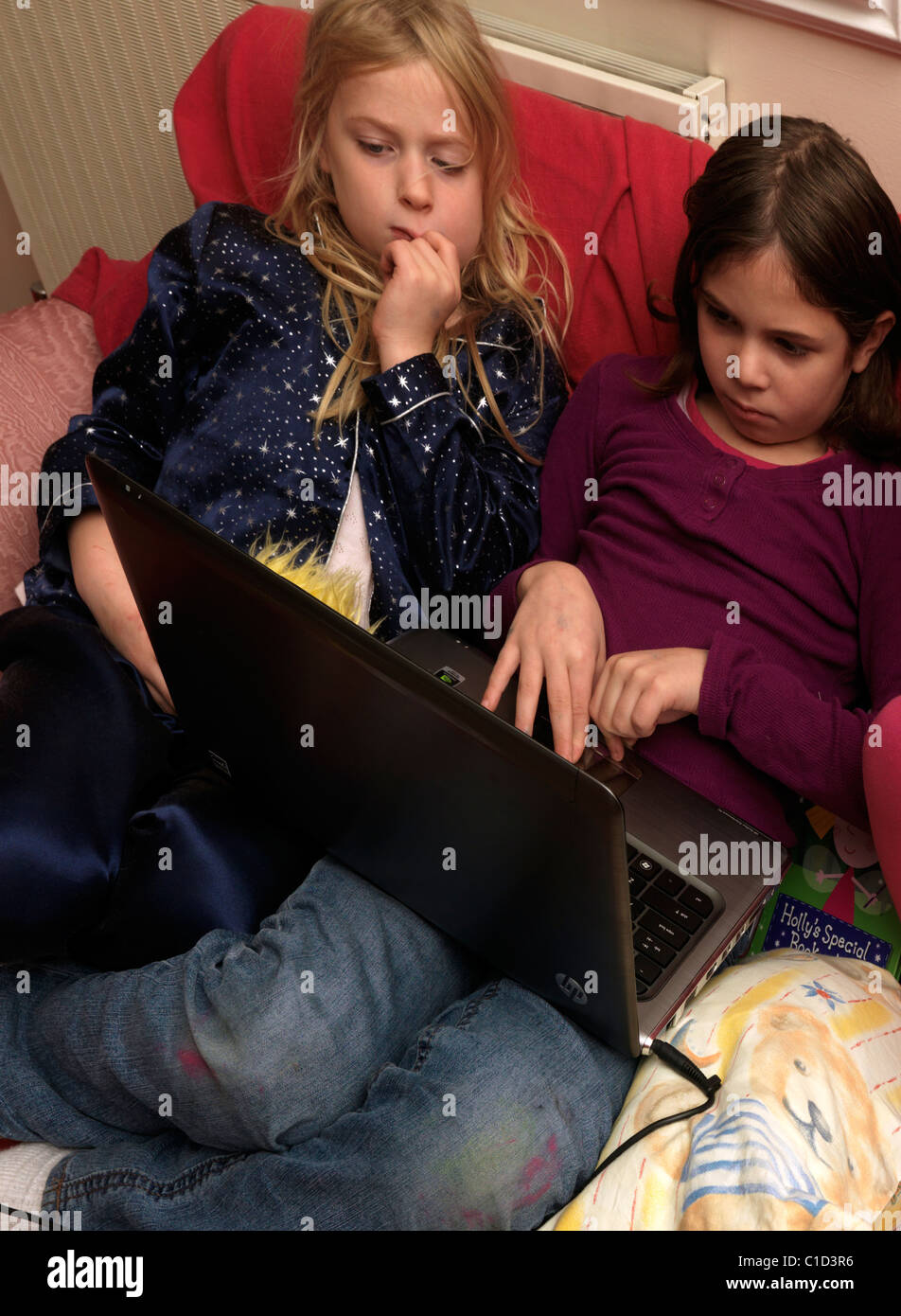 Girls Playing Computer Game On A Laptop In The Living Room Stock Photo ...