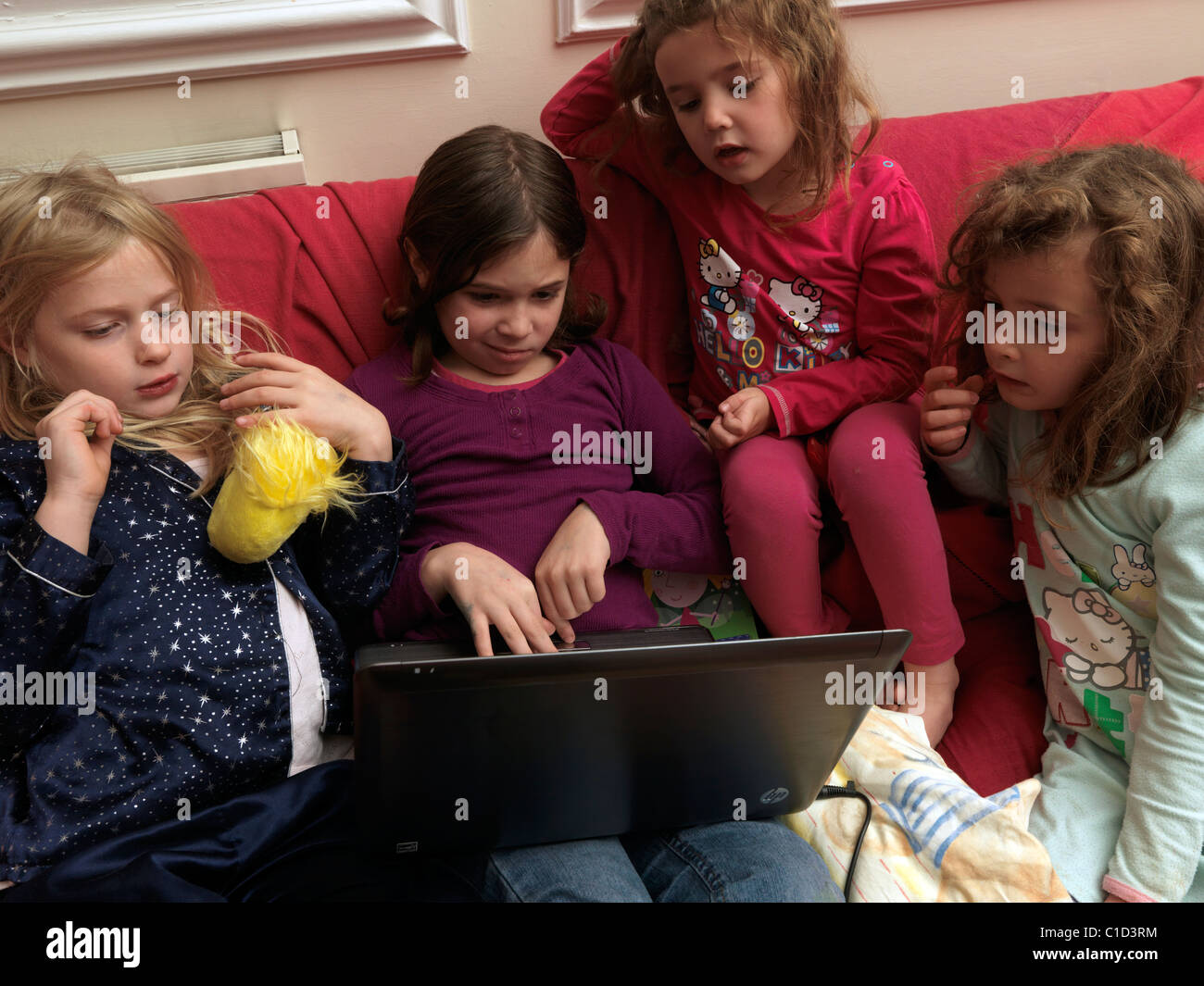 Girls Playing Computer Game On A Laptop In The Living Room Stock Photo ...