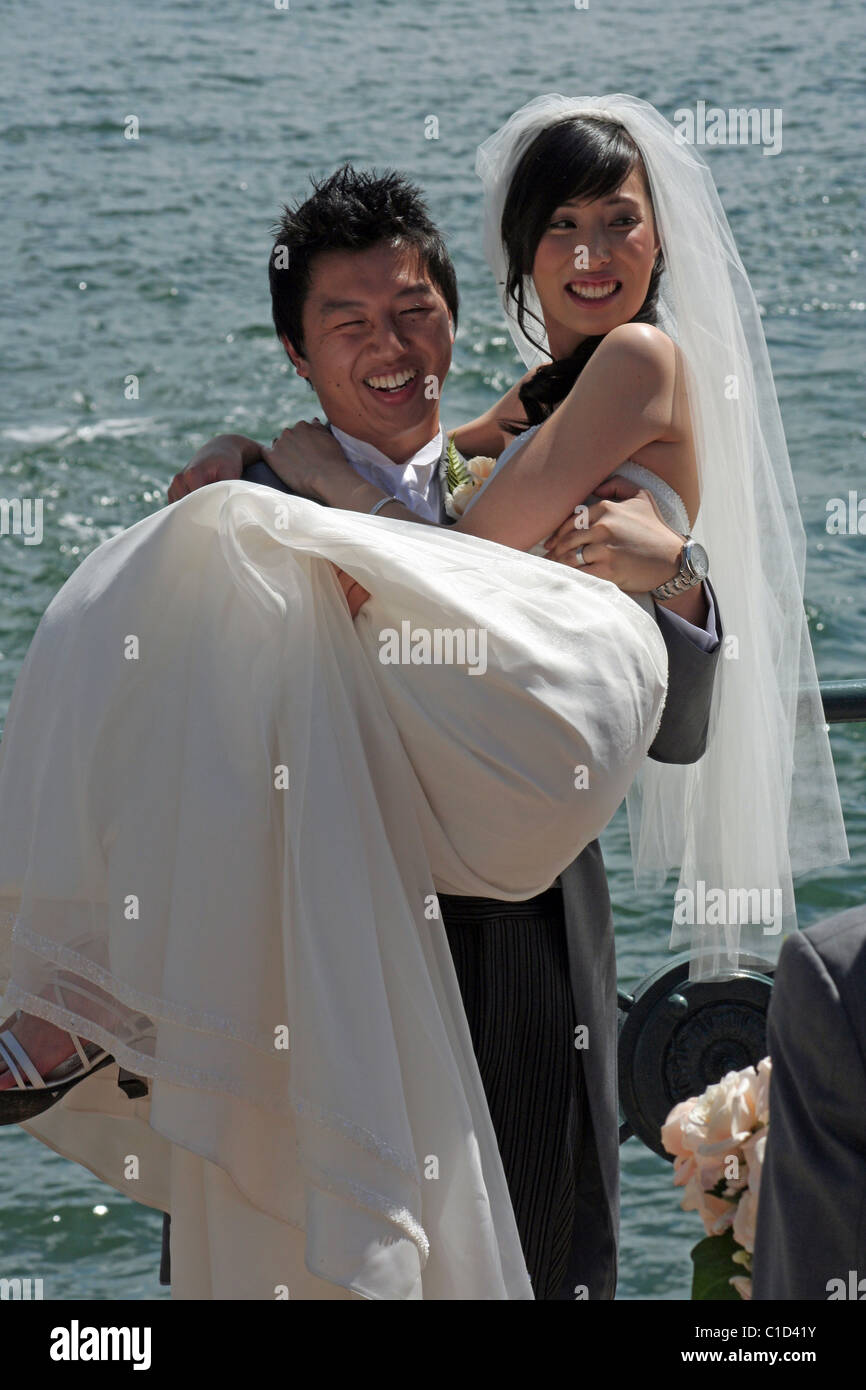Happily married young Asian couple, near the Harbour, Sydney, New South ...