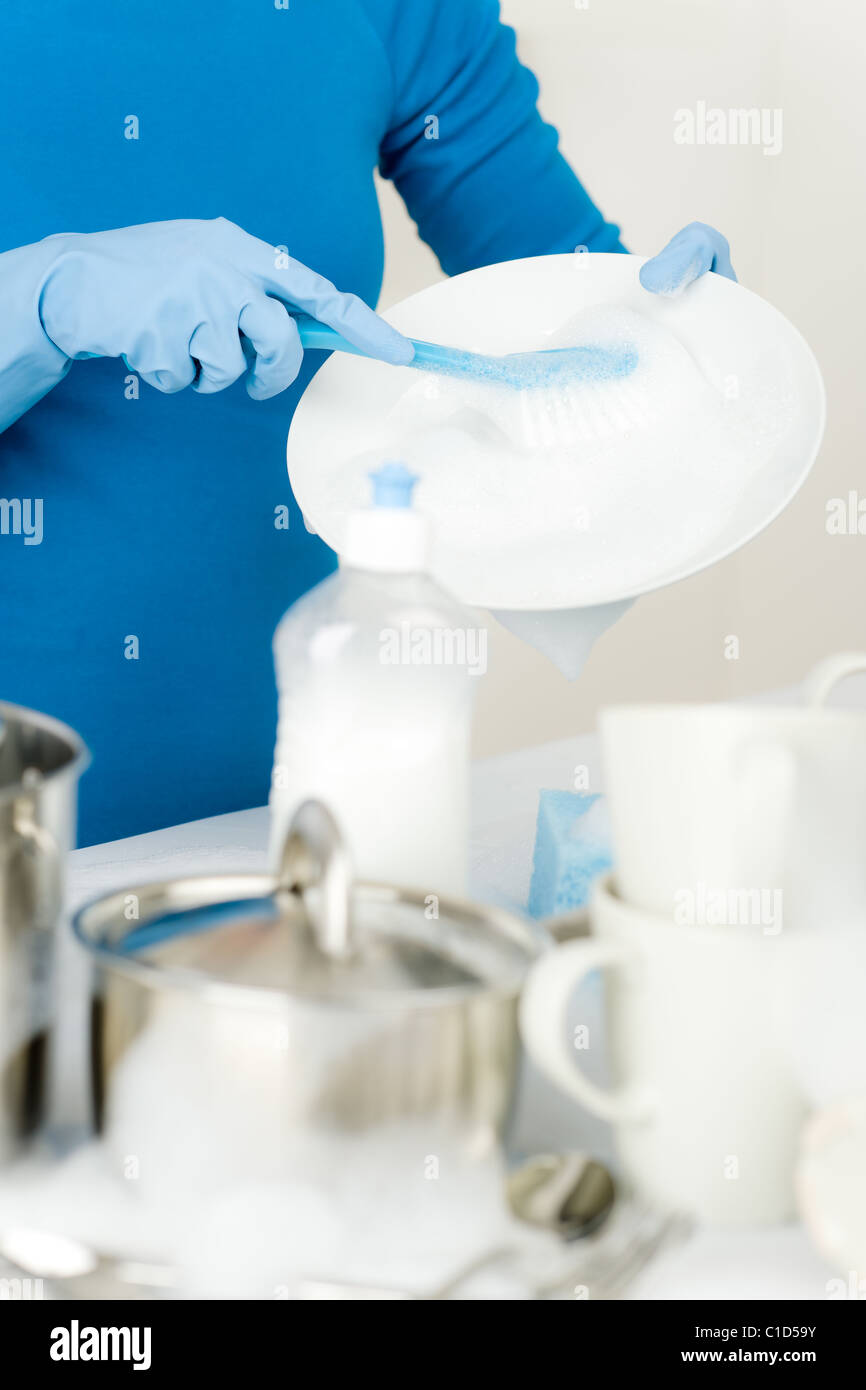 Washing dishes - hands with gloves in kitchen, housework Stock Photo ...