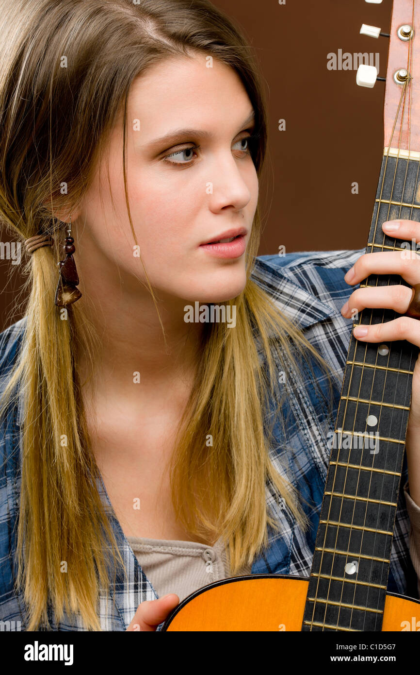Rock musician - young fashion female model posing with guitar Stock ...