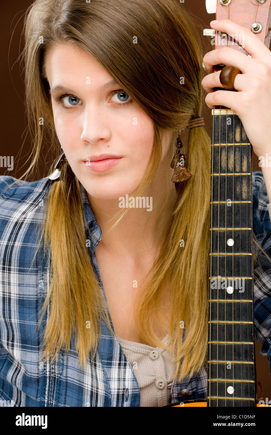 Rock musician - young fashion female model posing with guitar Stock ...