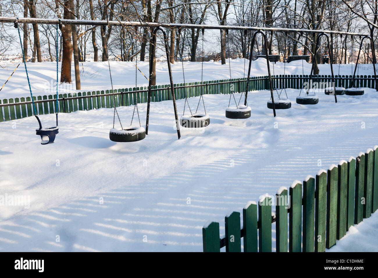 Swing set covered in snow Stock Photo - Alamy