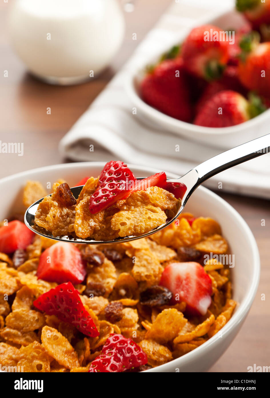 corn flakes and fruit on spoon and in bowl Stock Photo - Alamy