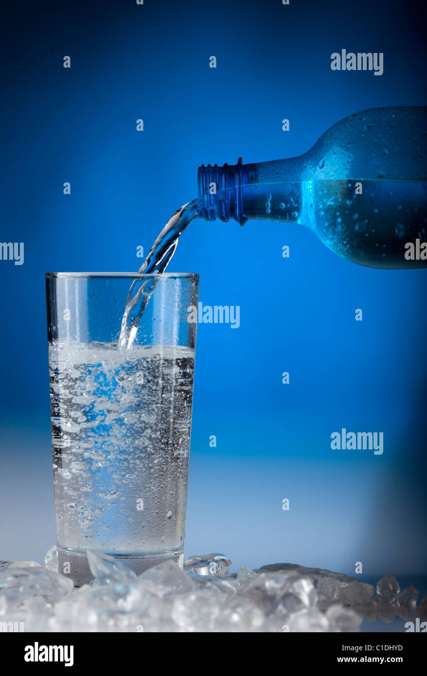 pouring mineral water from a blue bottle into a glass Stock Photo - Alamy